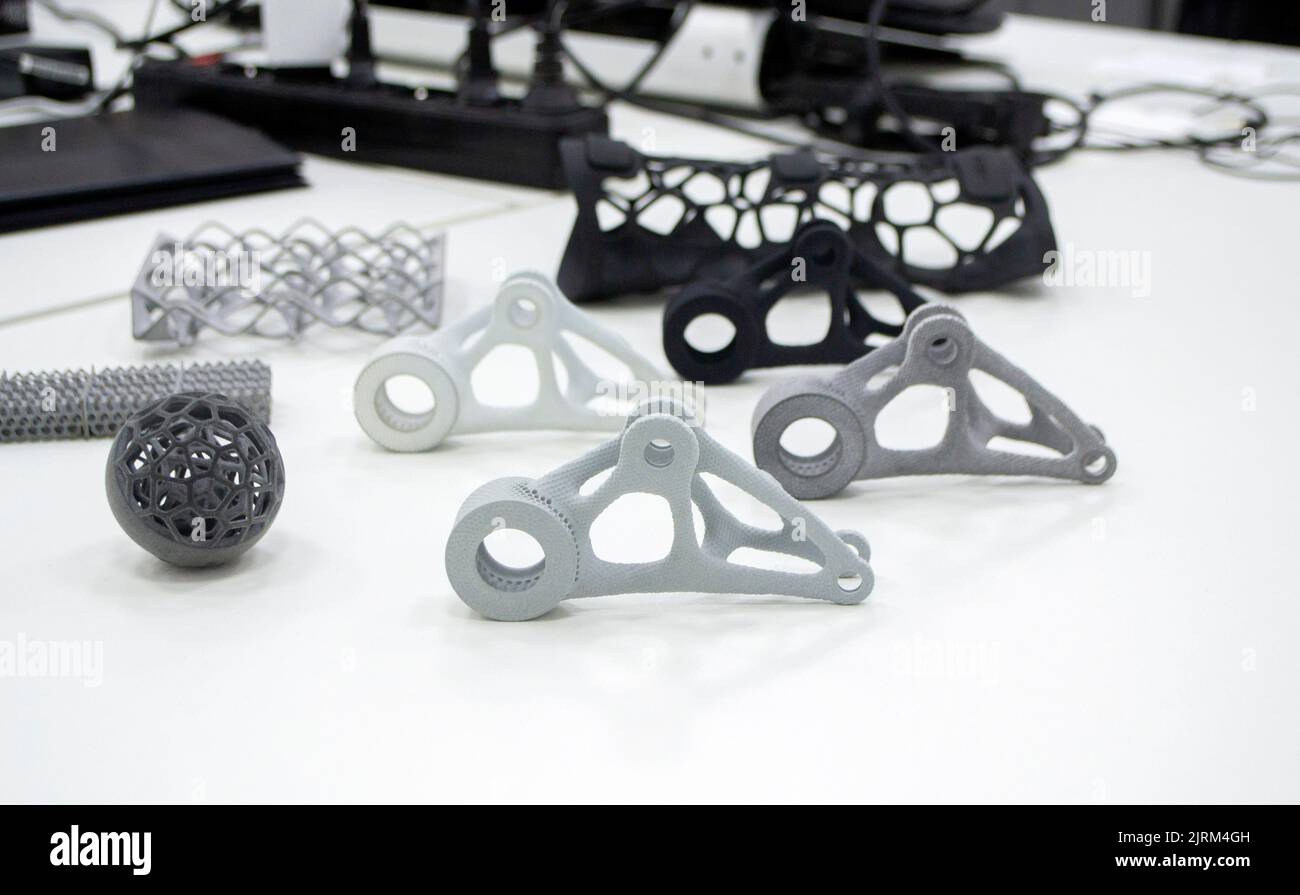 Black white gray models printed on 3D printer in laboratory office. Objects printed on 3D ...
