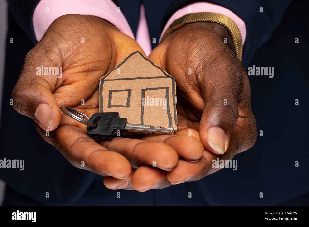 paper house and key in the palm of a black person's hand Stock Photo ...