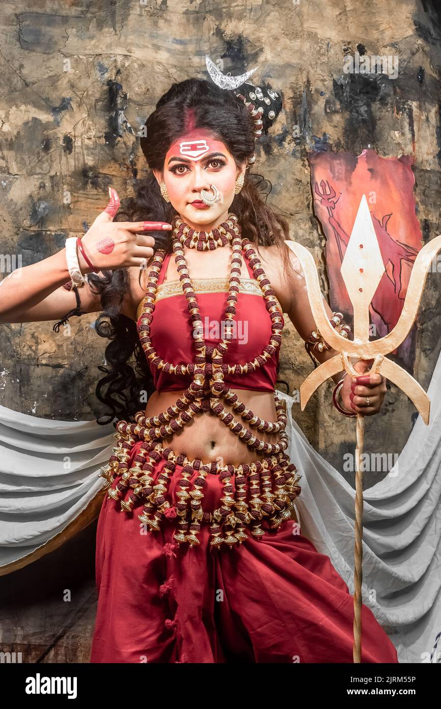 Concept Agomoni shoot with black haired Indian brunette woman face with ...