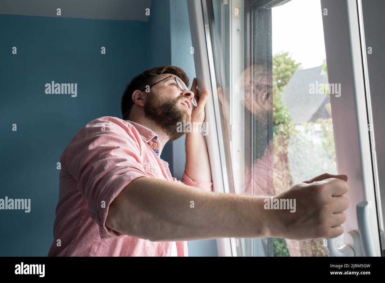 Man checks the work of a pvc window, he threw back the sash and looks ...