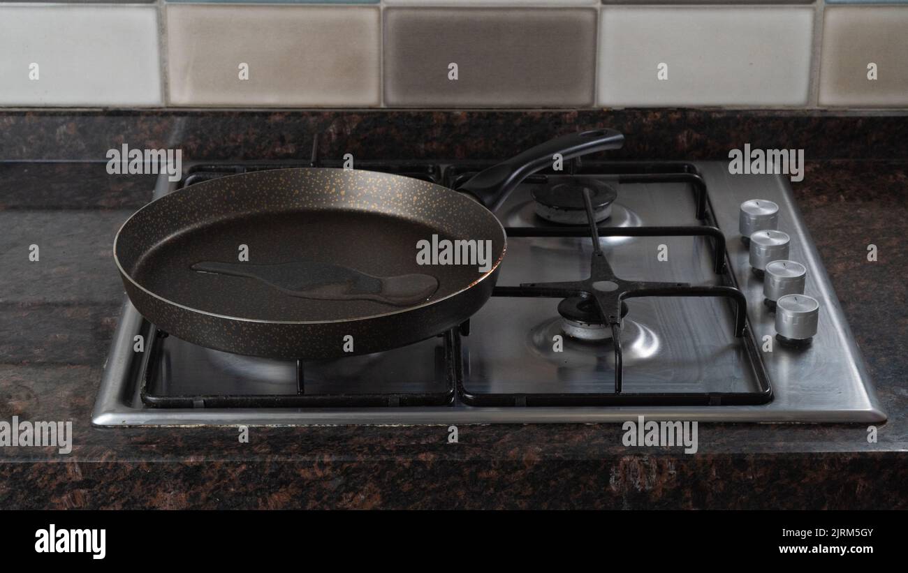 A frying pan with poured vegetable oil is on a gas stove Stock Photo ...
