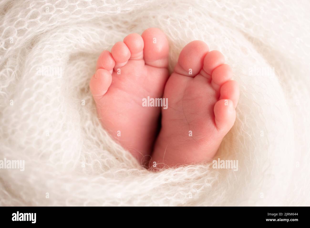 Soft feet of a newborn. Close-up of toes, heels and feet of a newborn ...