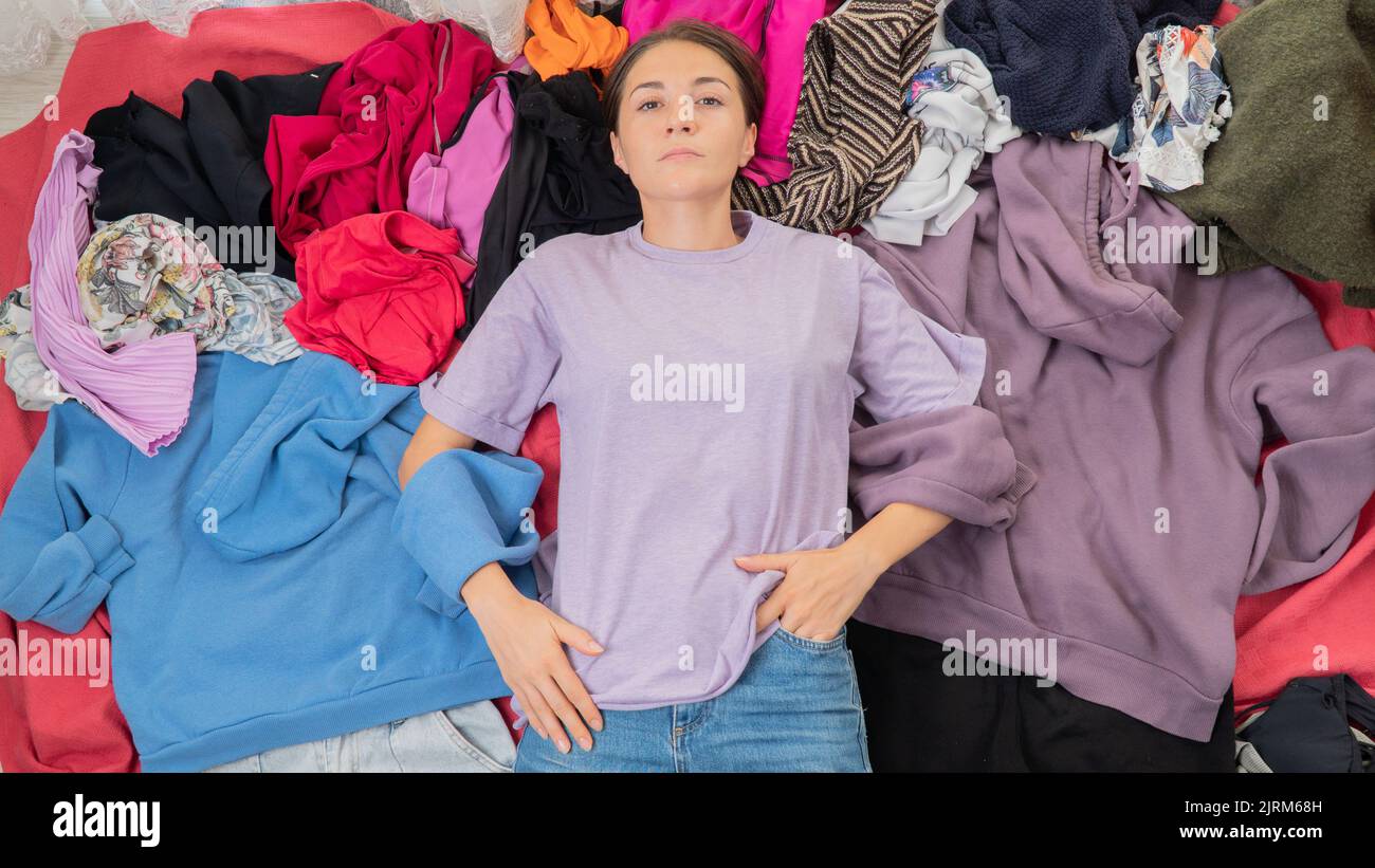 Shopaholic, women's wardrobe - a woman in a pile of clothes, nothing to ...