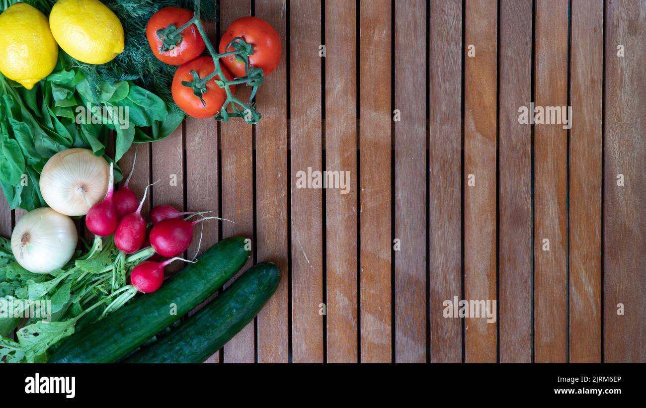set of vegetables and greens on the side flat background on the tree ...