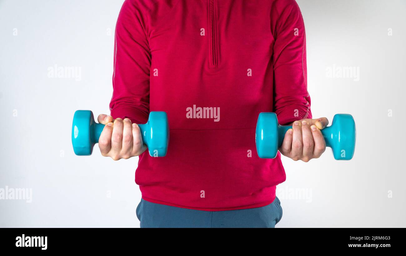 Athletic man with dumbbells in his hands for training Stock Photo - Alamy