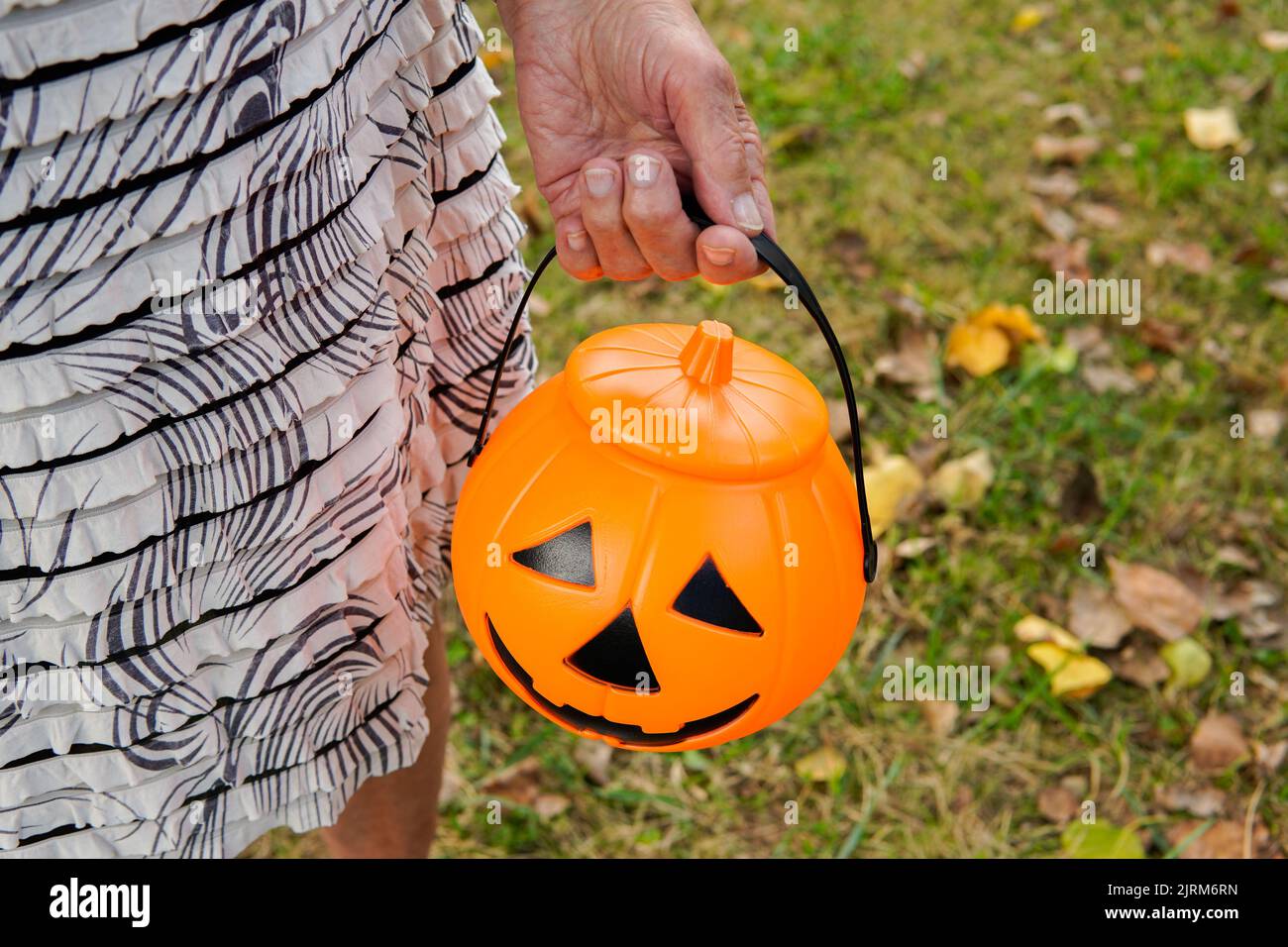 Halloween pumpkin held by an old woman Stock Photo - Alamy