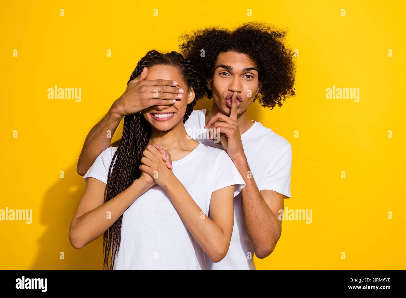 Photo of two cheerful funny people guy show shh symbol cover lady eyes ...