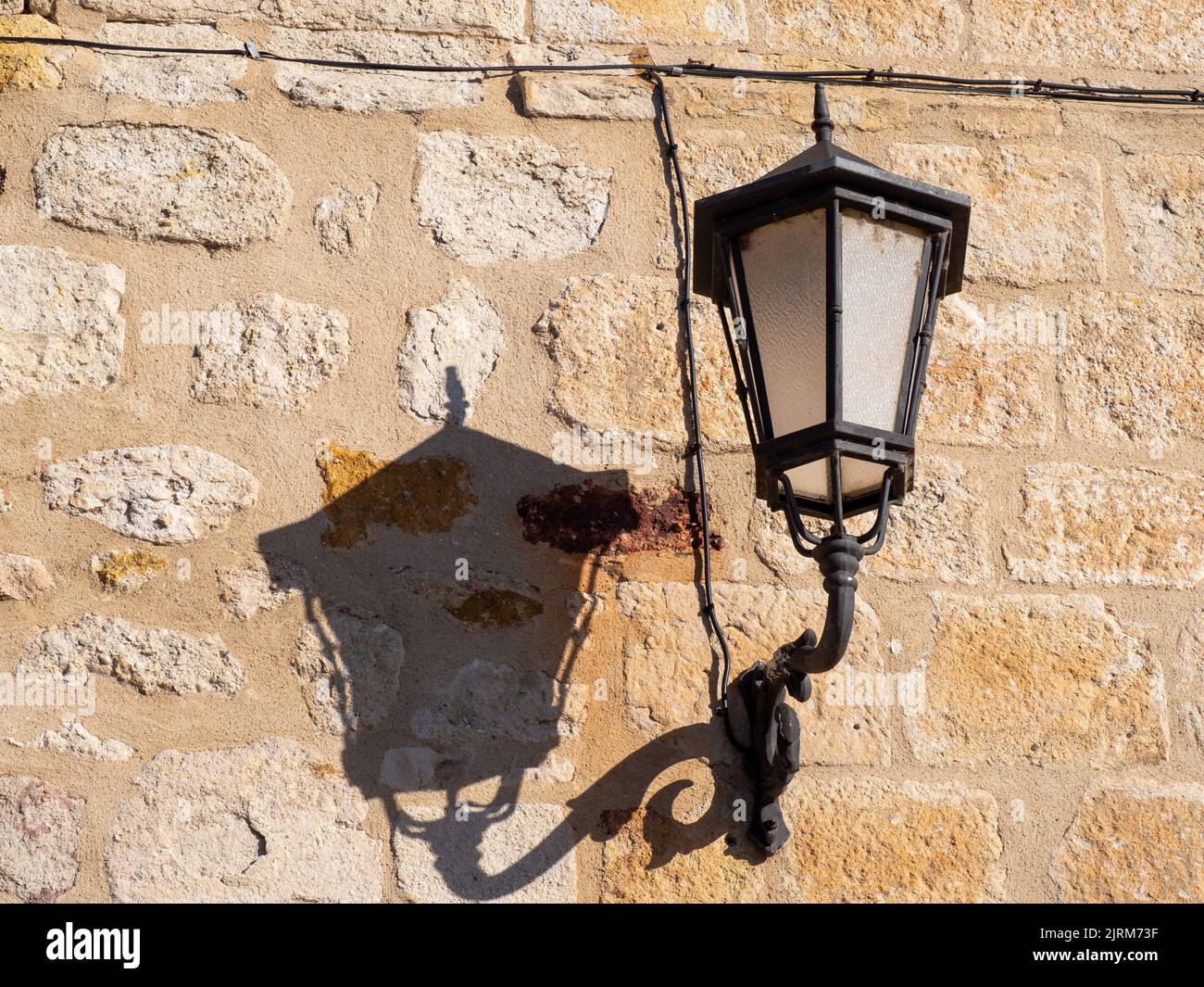 antique street lamp in a Romanesque building in a European city Stock ...