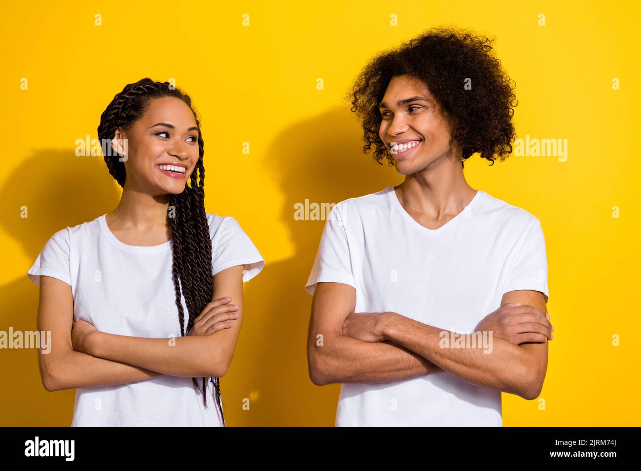 Photo of two positive satisfied people folded hands look each other ...