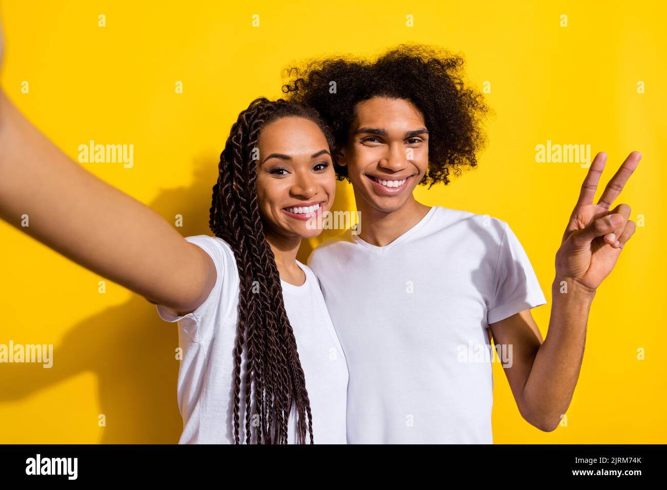 Photo of two positive friendly people take selfie hand finger show v ...