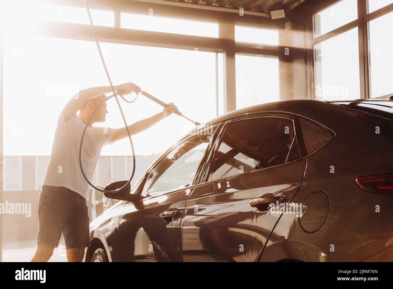 Man using water hose wash hi-res stock photography and images - Alamy