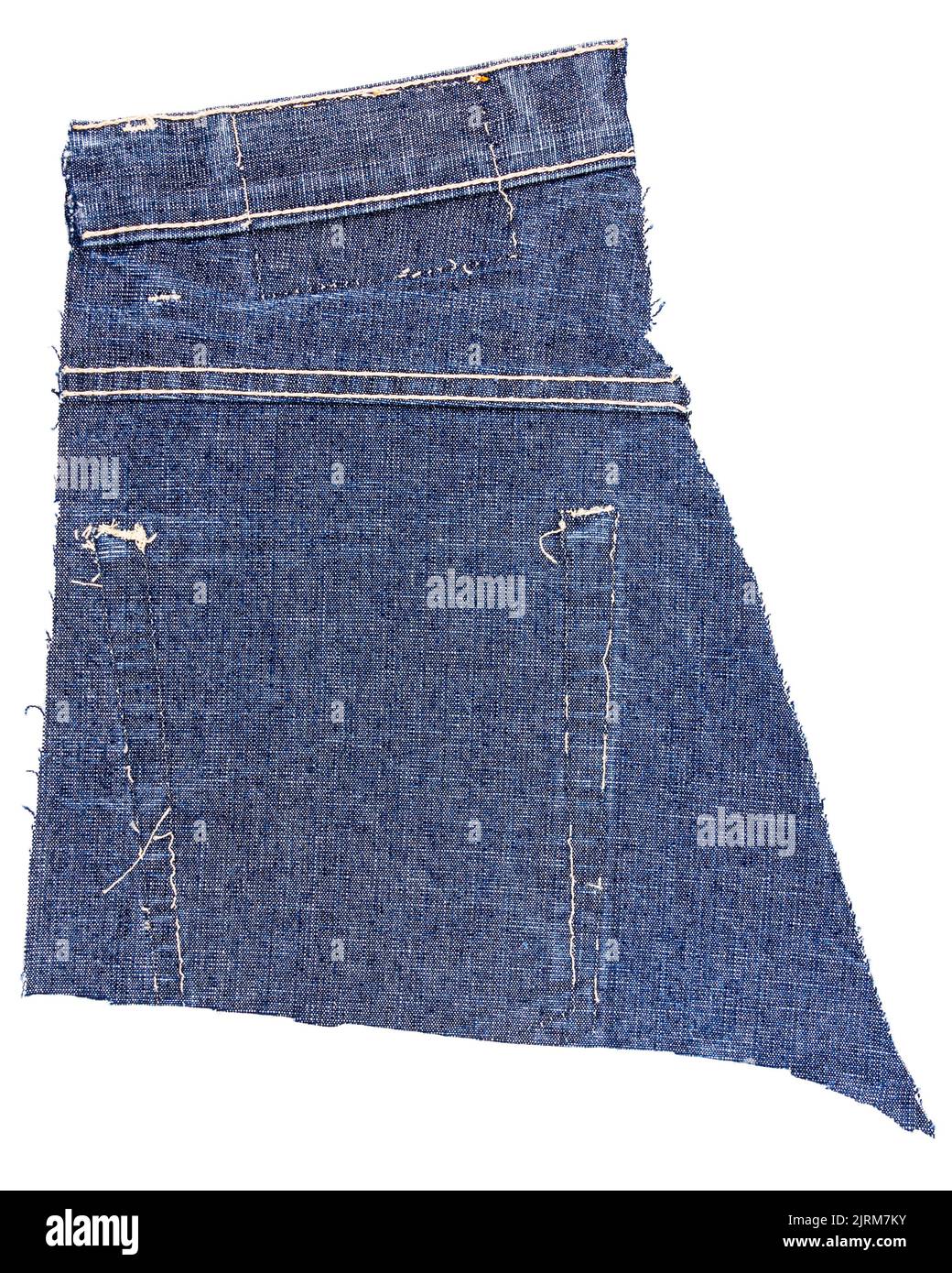 Piece of blue jeans fabric with a ripped of back pocket isolated on ...