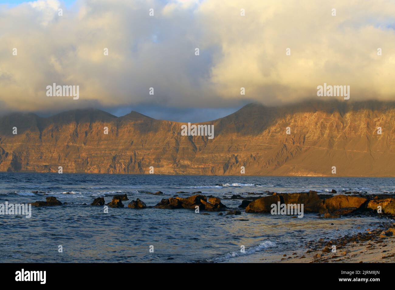 Views of the Risco de Famara from San Juan beach during sunset Stock ...