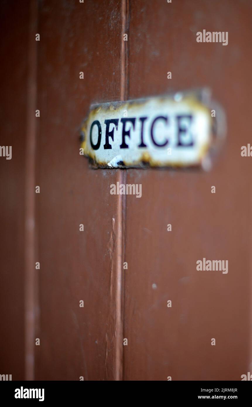 vintage distressed enamel office door sign Stock Photo - Alamy