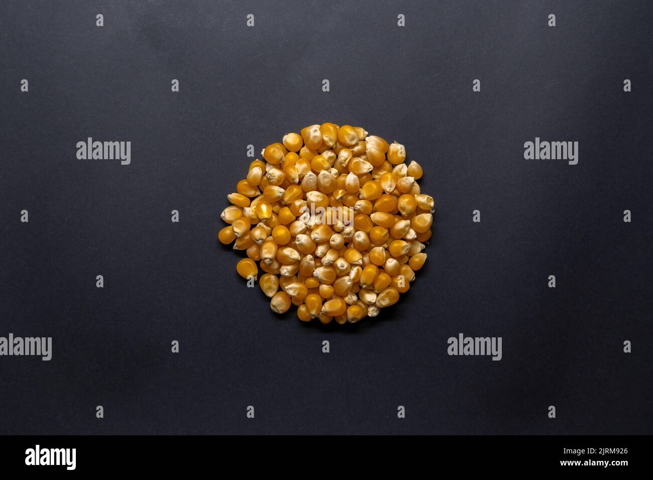 Raw corn kernels isolated on black background, corn in round shape ...