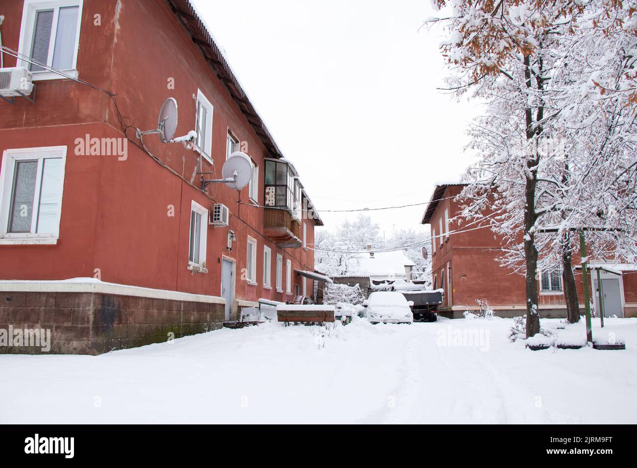 Sleeping residential area with red two-story houses in the snow in ...