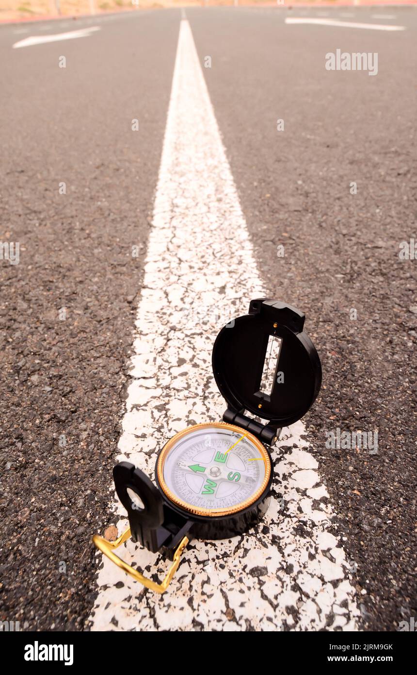 Travel Concept Compass on the Asphlat Road Stock Photo - Alamy