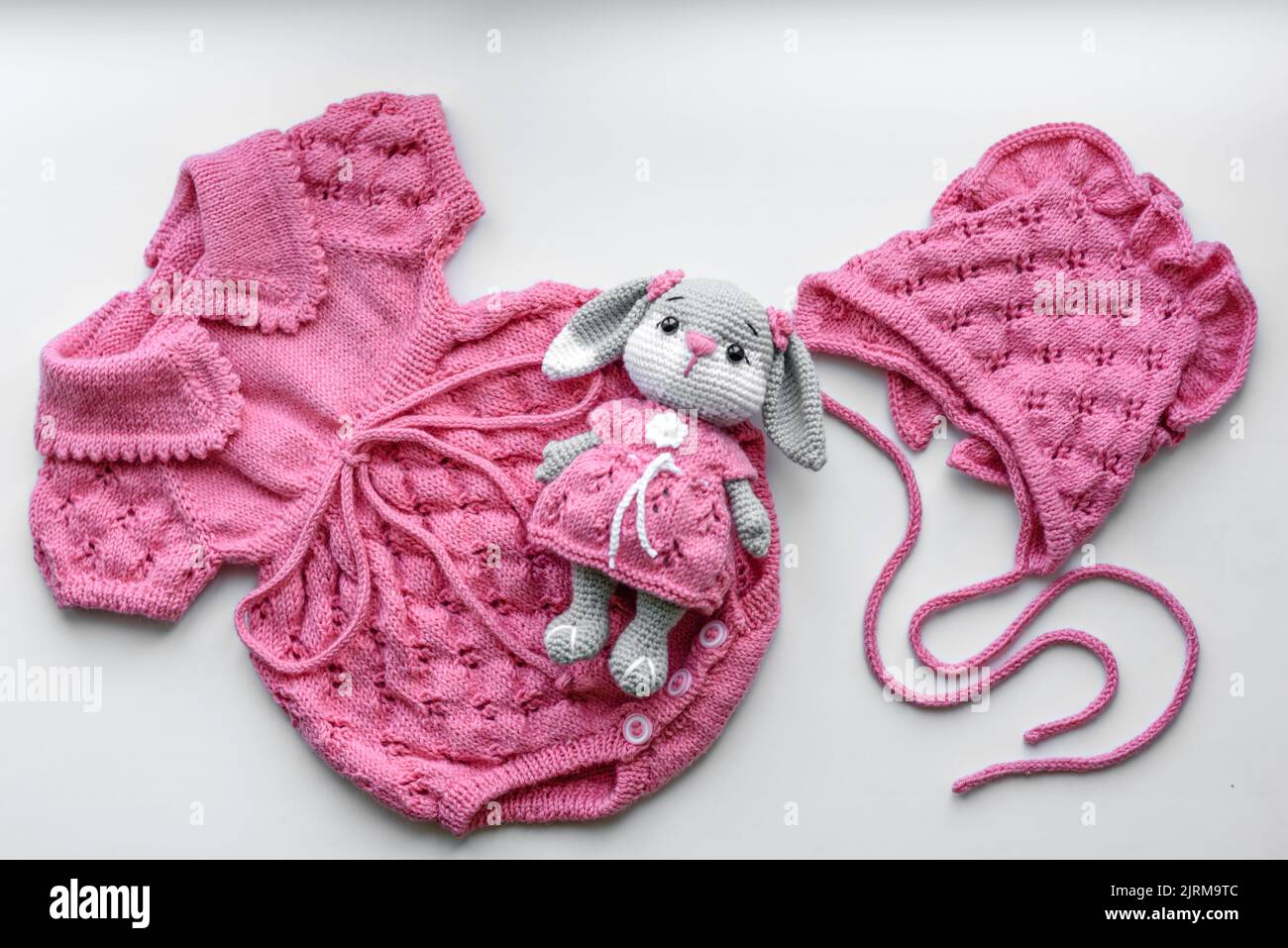 Beautiful baby knitted clothes and a toy for a newborn baby. Hobby ...