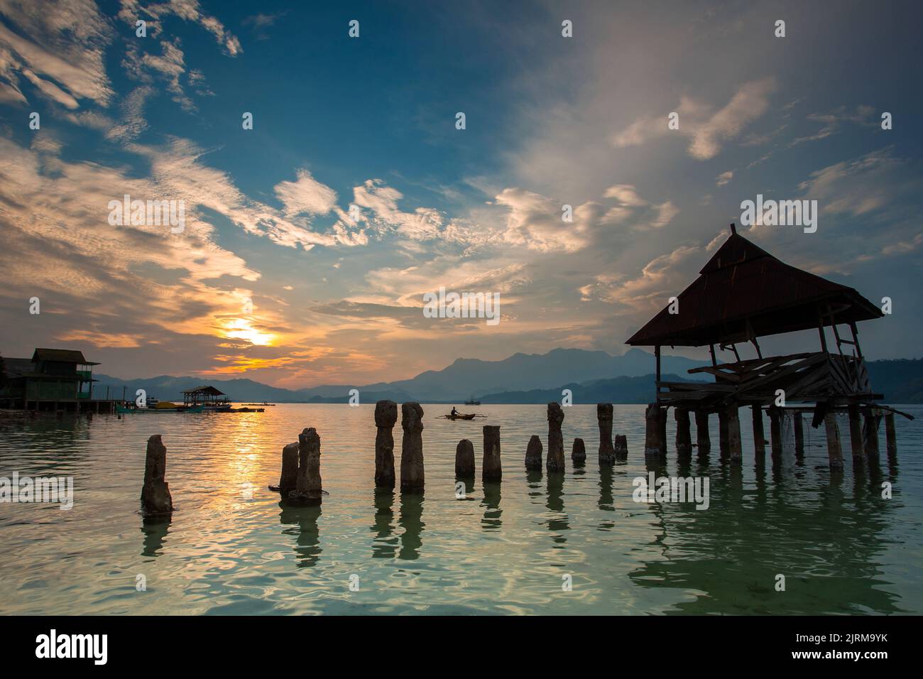 stunning sunset on the beach Tanjung Putus Lampung. building on a clear ...
