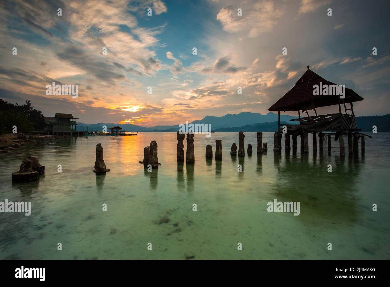 stunning sunset on the beach Tanjung Putus Lampung. building on a clear ...