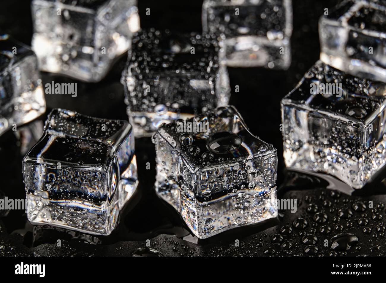 Multiple frozen ice cubes on a Black background Stock Photo - Alamy