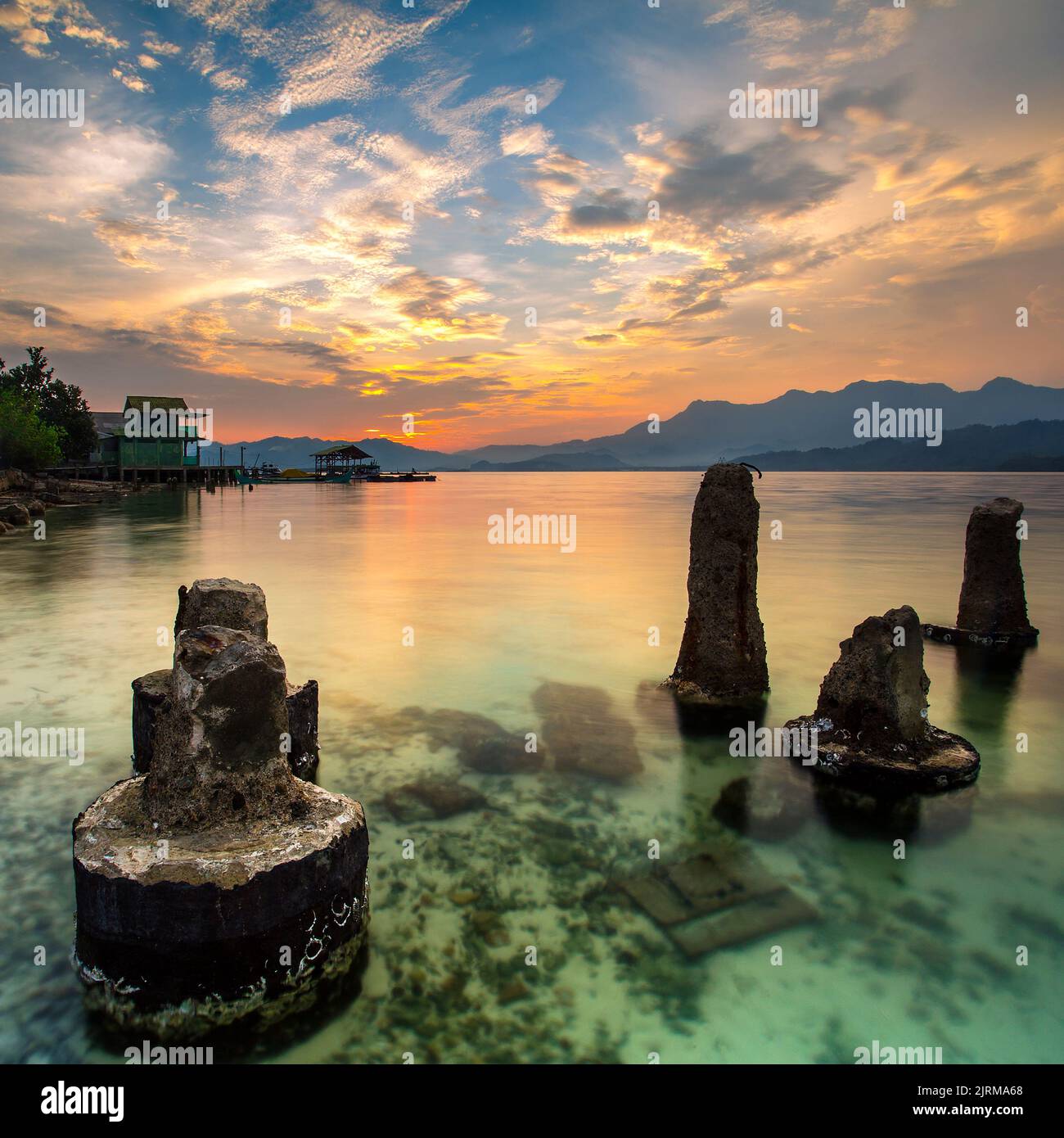stunning sunset on the beach Tanjung Putus Lampung. building on a clear ...