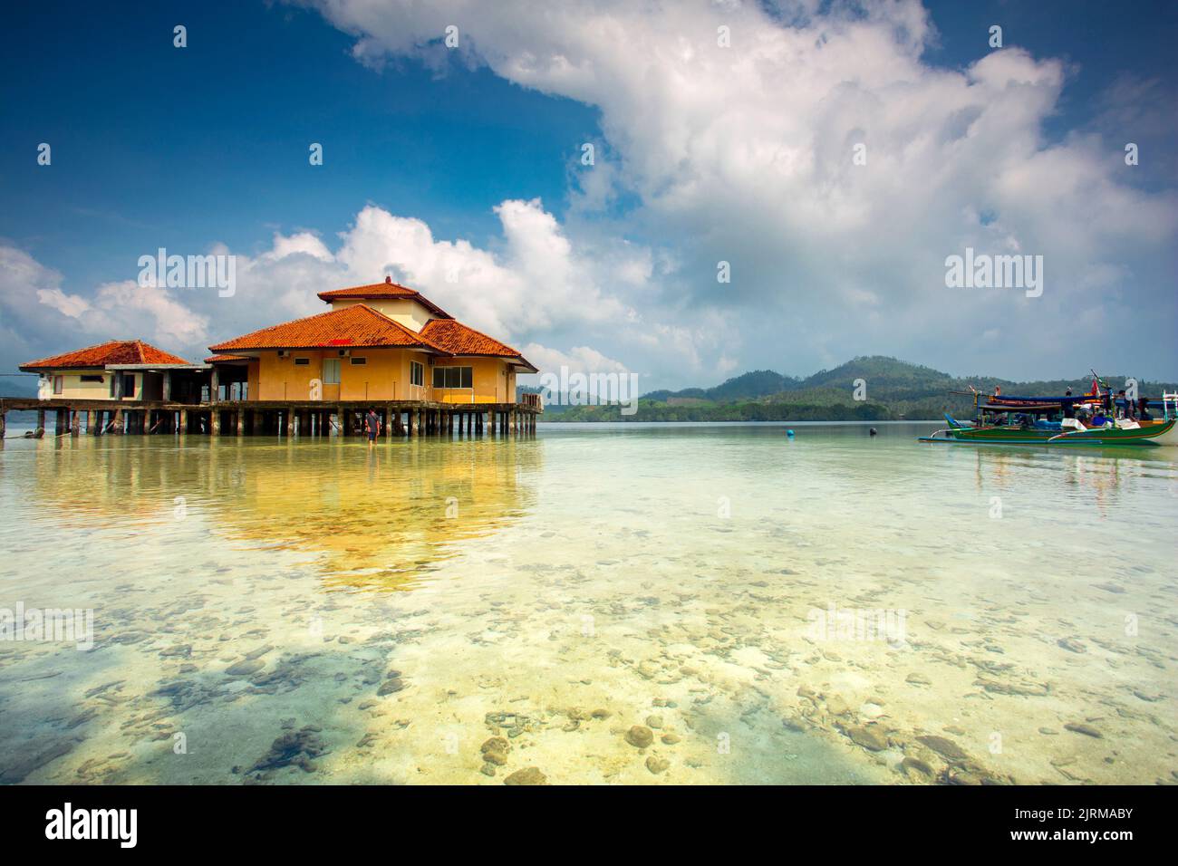 building on a clear sea under a blue sky. Indonesian landscapes ...