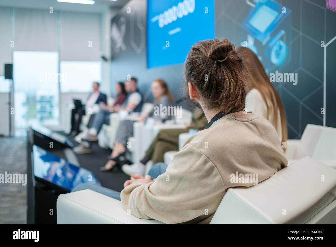 Back view of anonymous male in casual clothes sitting in armchair and ...