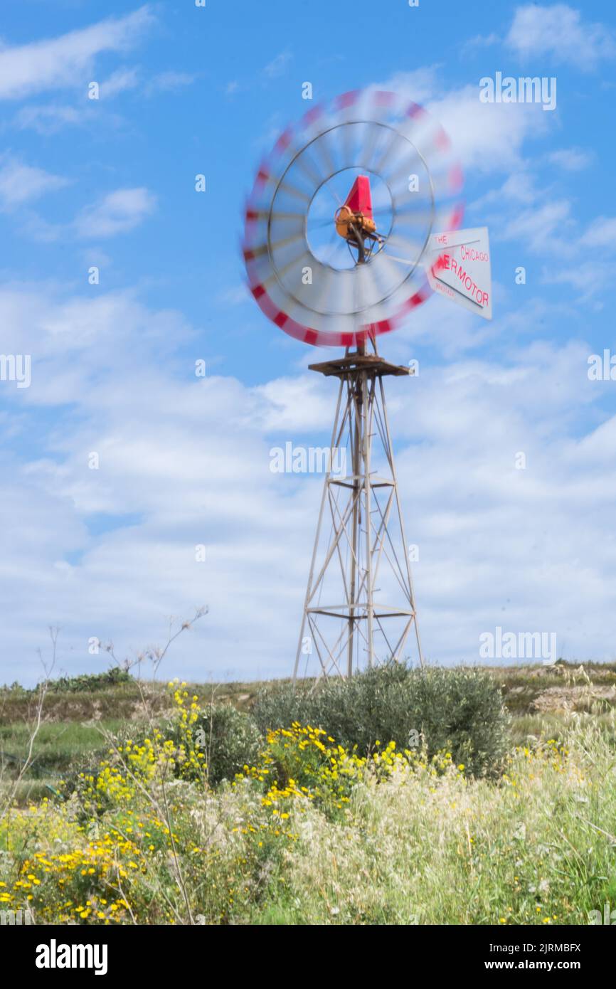 A functioning wind pump, with rotating multi bladed rotor in motion ...