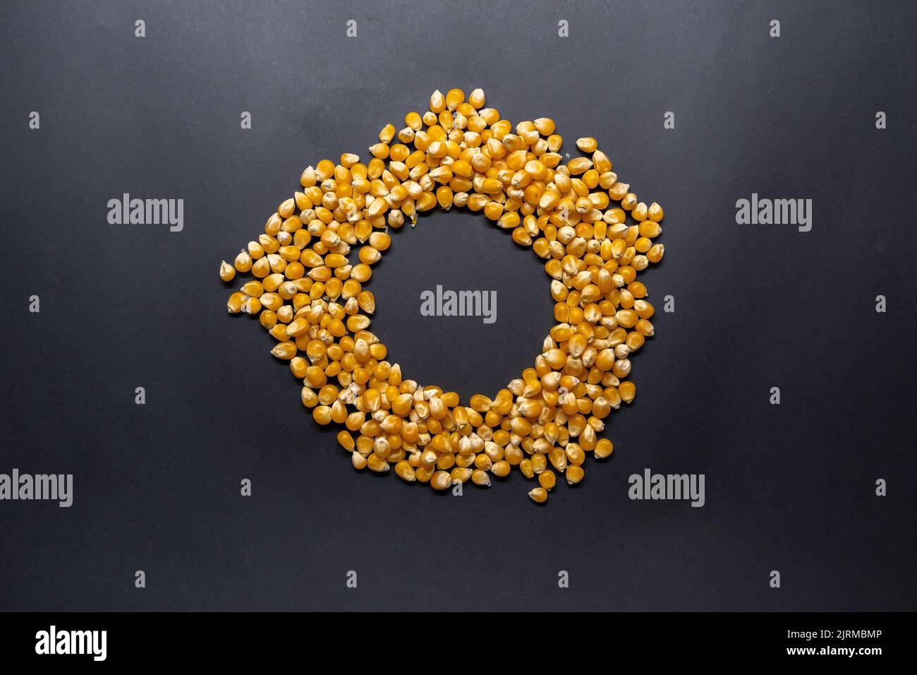 Raw corn kernels isolated on black background, corns in the shape of a ...