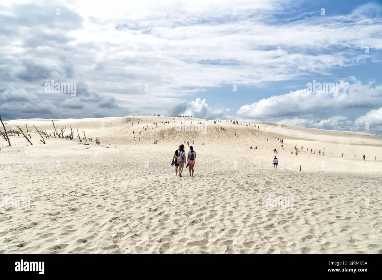 People explore in Lacka dune in Slowinski National Park in Poland ...