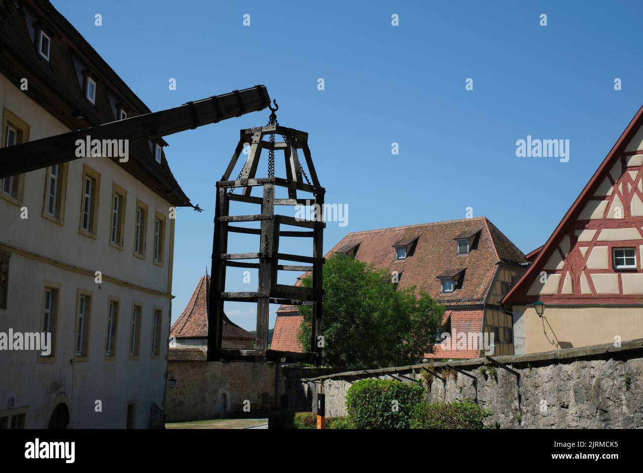 Courtyard of Medieval Crime Museum, wooden torture cage, device for ...