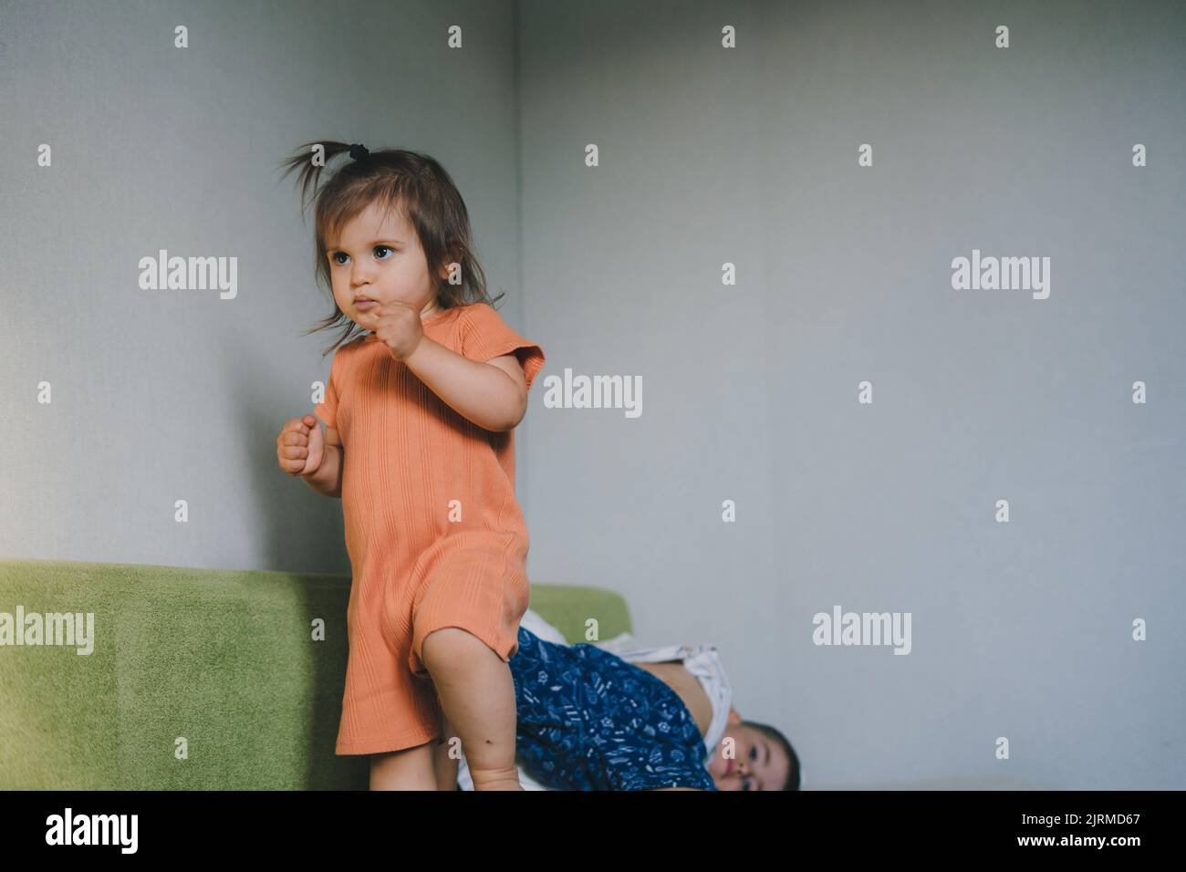 Children restless on the sofa waiting for their mother. Happy family ...
