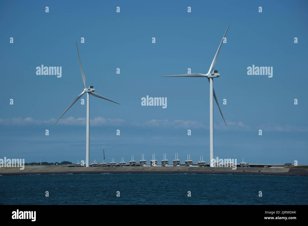 View of Neeltje Jans flood barrier with wind turbines Stock Photo - Alamy