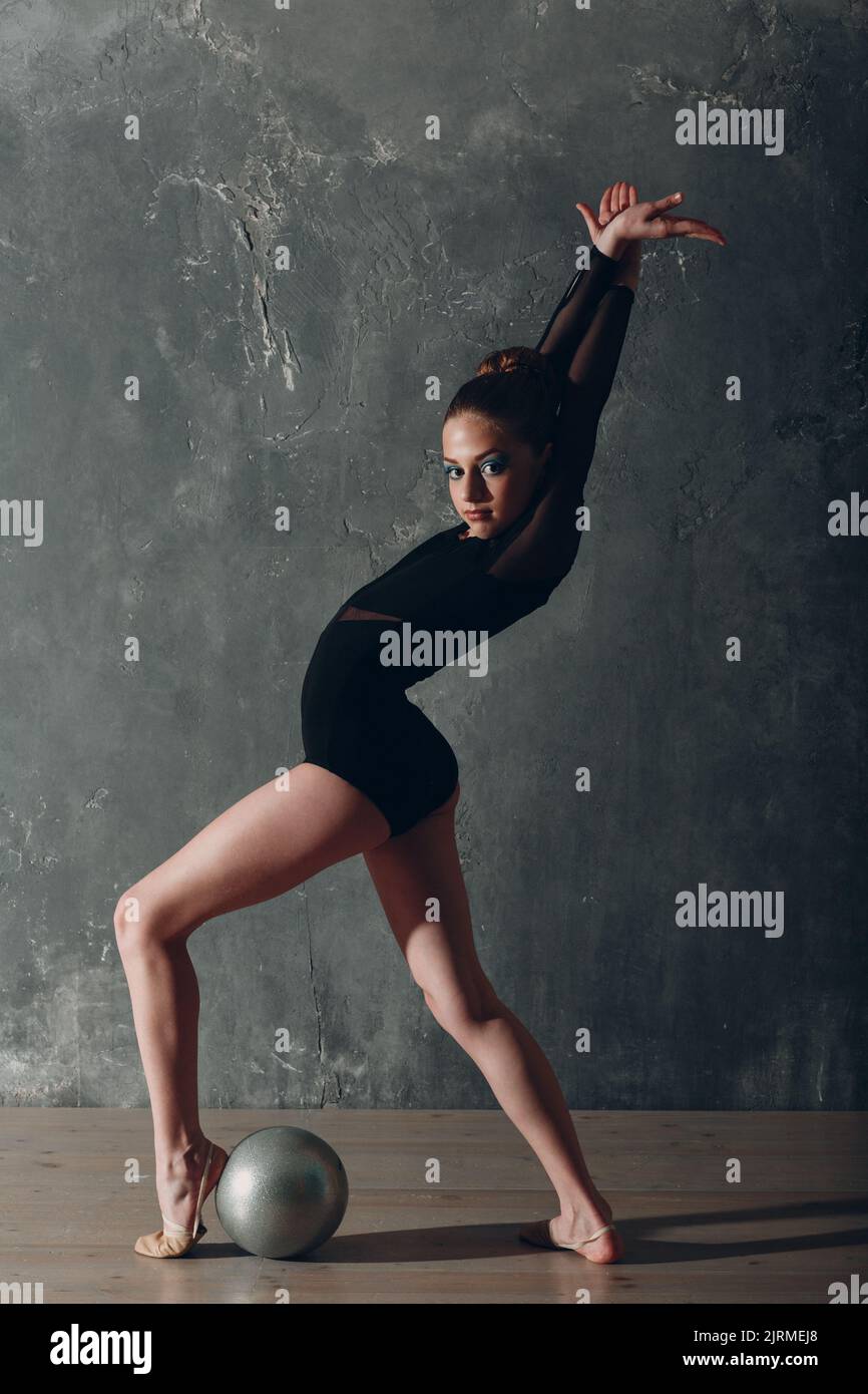 Young girl professional gymnast woman dance rhythmic gymnastics with ...