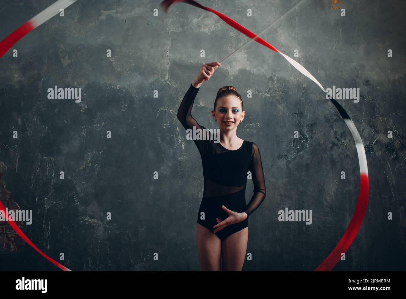 Young girl professional gymnast woman dance rhythmic gymnastics with ...