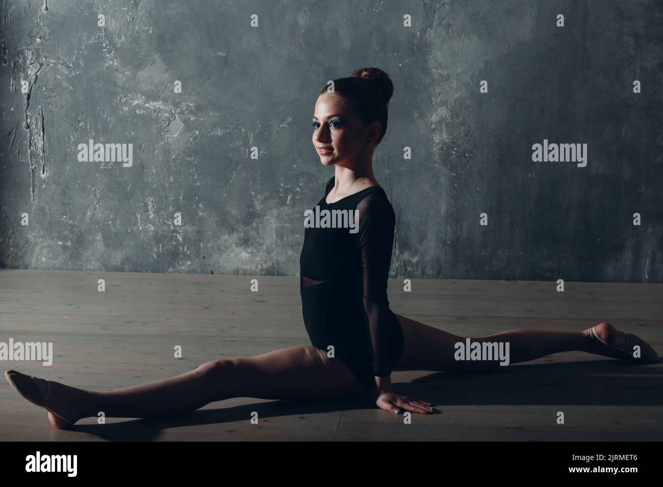 Young girl professional gymnast woman rhythmic gymnastics doing split ...