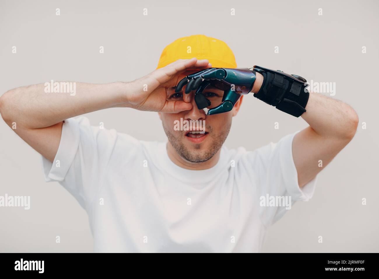 Young disabled man looking binoculars gesture with artificial ...