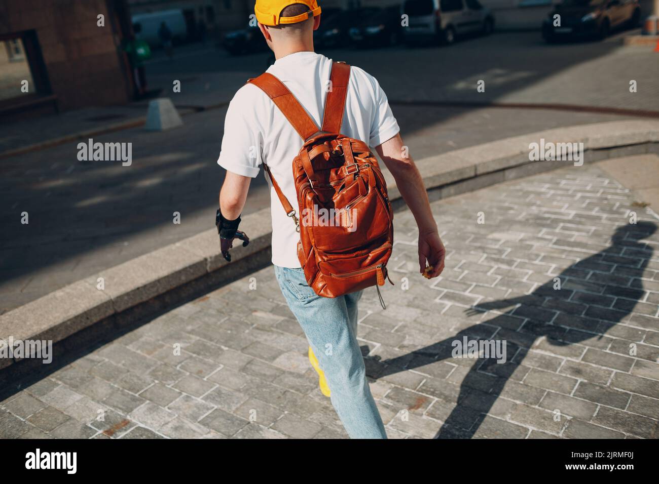 Young disabled man with artificial prosthetic hand in casual clothes at ...