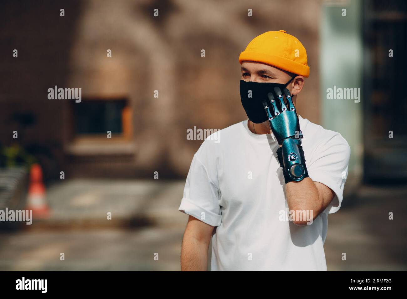 Young disabled man with artificial prosthetic hand wearing medical ...