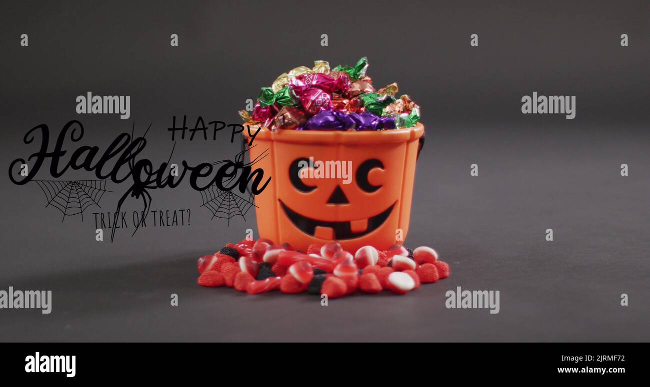 Happy halloween text banner with spider icon against pumpkin shaped ...