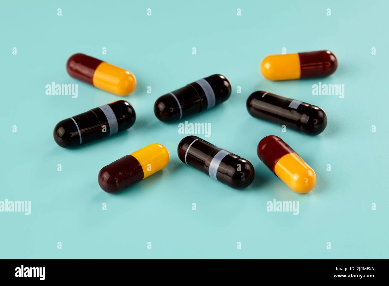Two different kinds of capsules scattered on the cyan background Stock ...