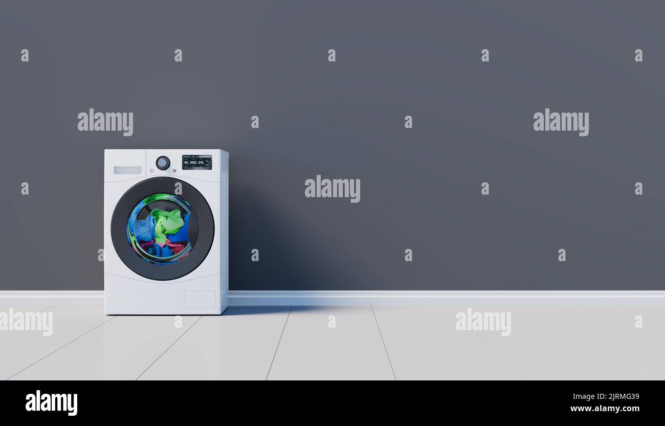 Washing machine with clothes inside standing on a tile against a gray ...