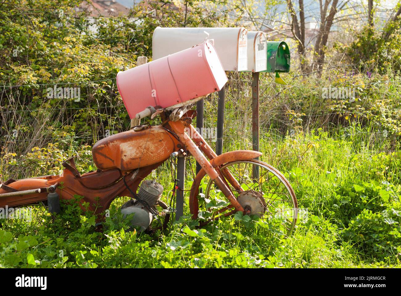 recycled retro mailboxes with old rusty vintage motorcycle in the ...