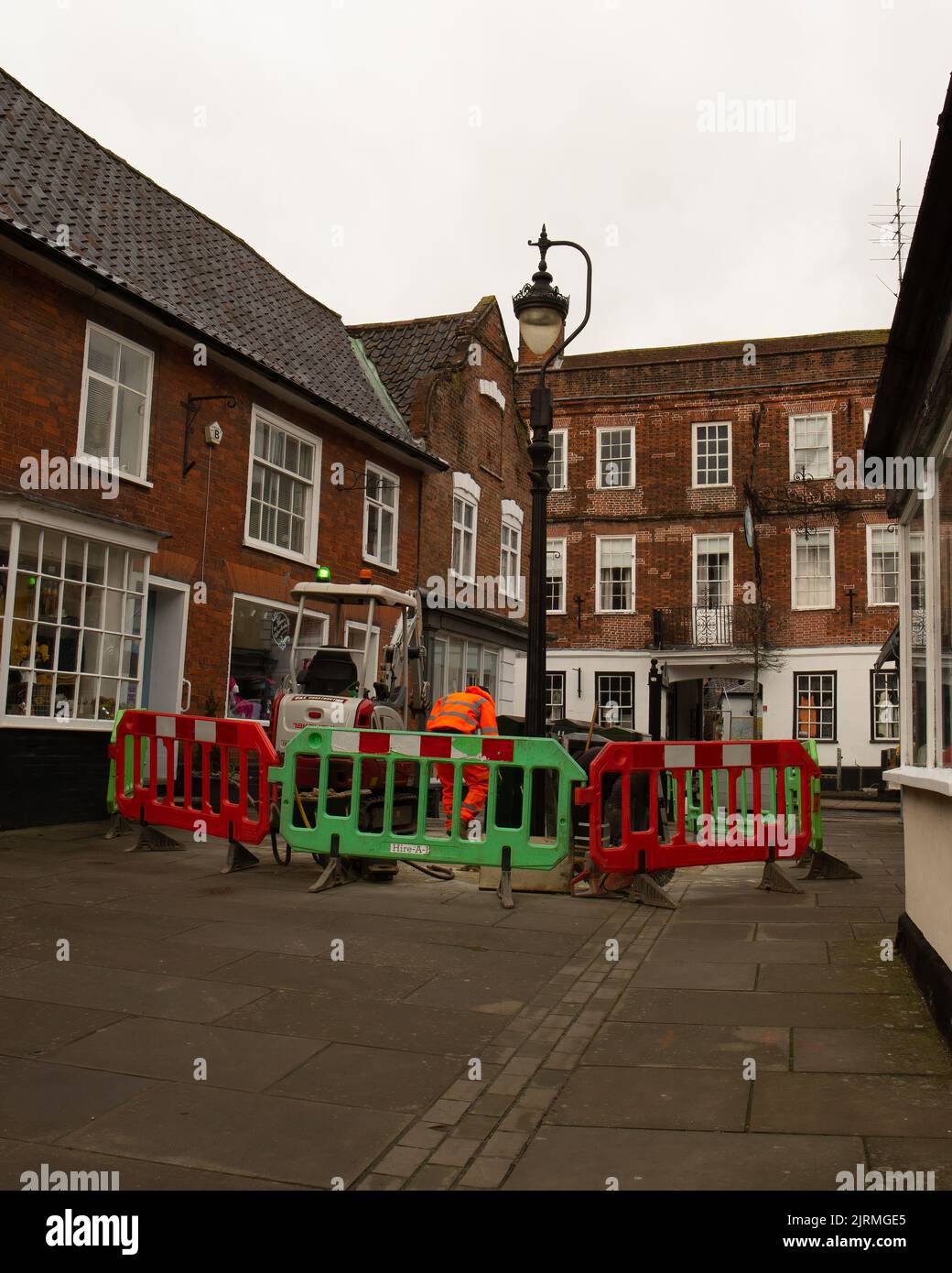 The vertical view of men working covered with temporary barriers in a ...