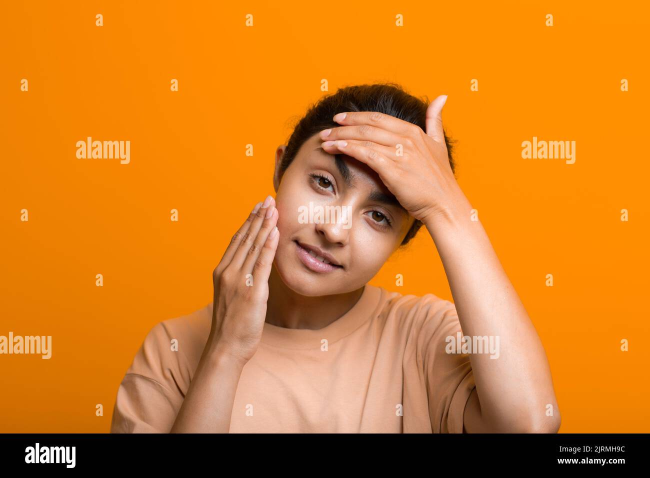 Close up portrait of young indian american woman doing facebuilding ...