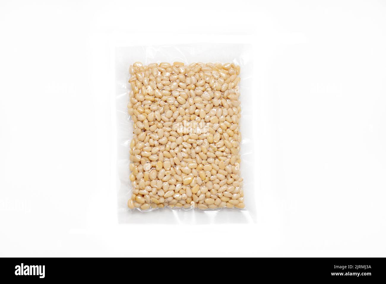 Peeled Pine Nut In Transparent Vacuum Small Plastic Packaging On White ...