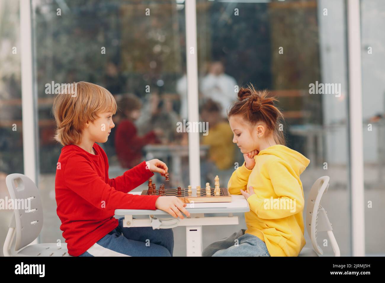 Little kids playing chess at kindergarten or elementary school Stock ...