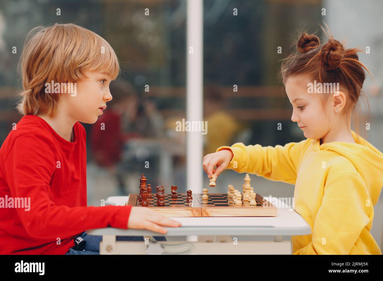 Little kids playing chess at kindergarten or elementary school Stock ...