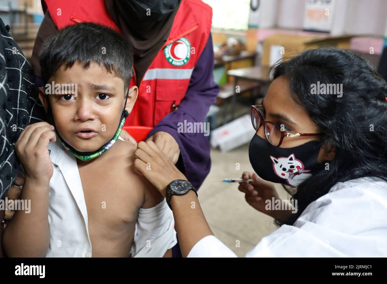 Dhaka, Bangladesh - August 25, 2022: A child gets his first dose of the COVID-19 vaccine at ...
